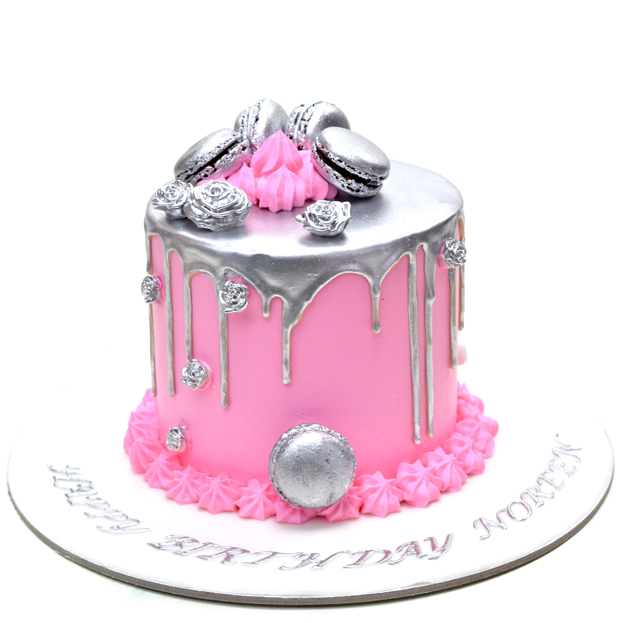 Pink Cake with silver drip and macaroons