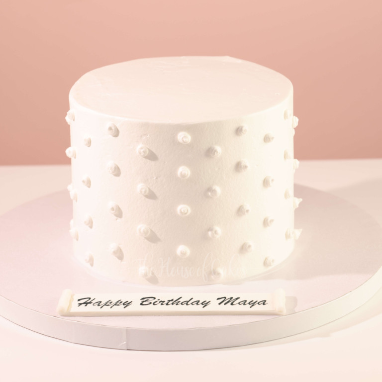 Simple Cream Dots Cake at The House of Cakes Dubai